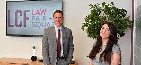 Two newly qualified lawyers at LCF Law